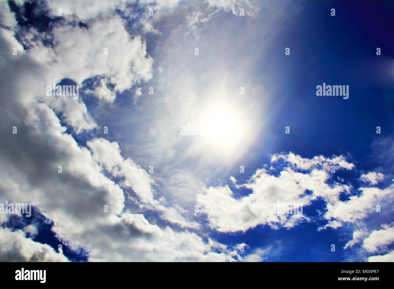Image of the Sun and fluffy blue sky Stock Photo - Alamy