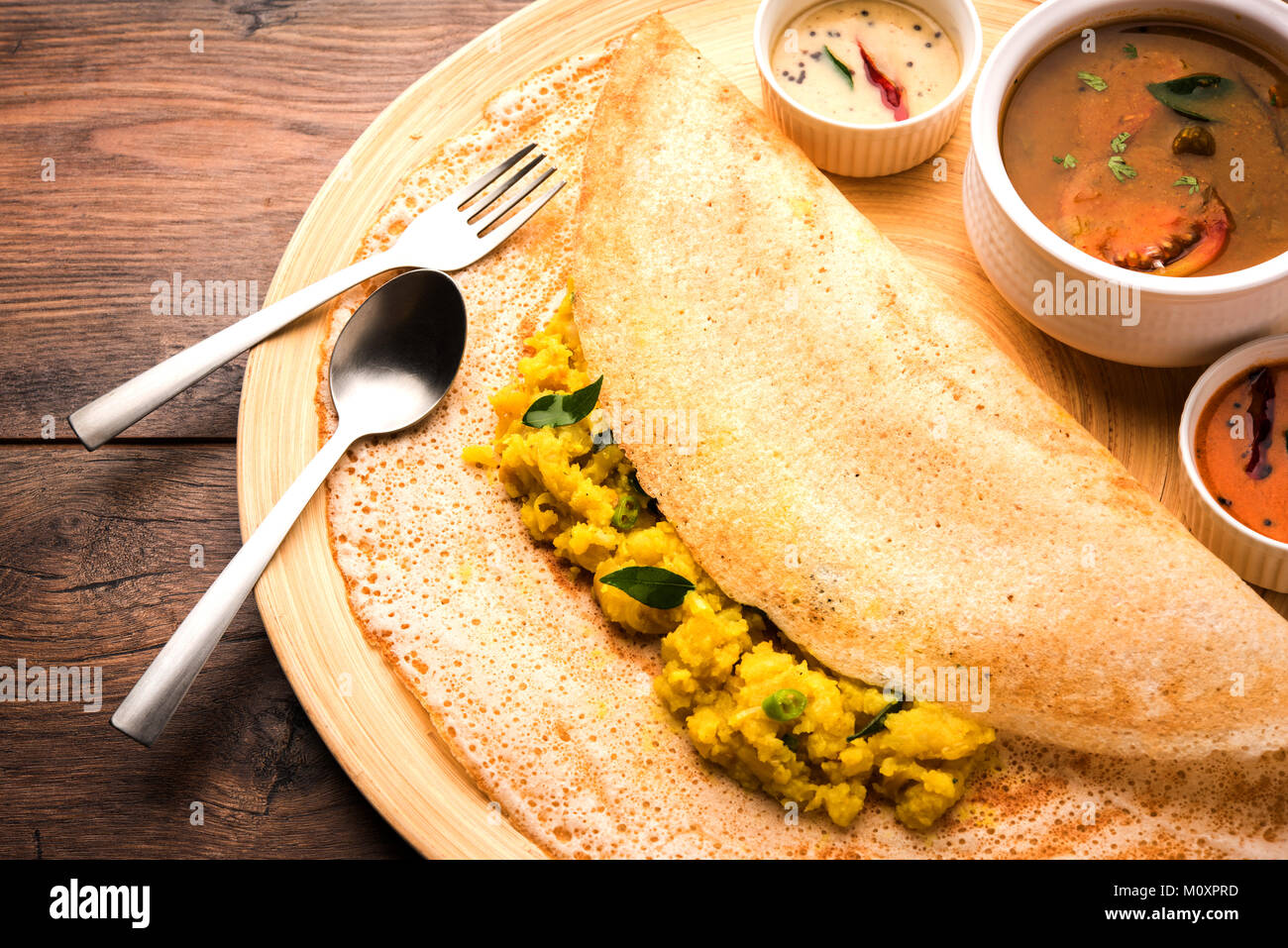Masala dosa with chutney and sambar and potato sabzi. Cone, triangle or ...