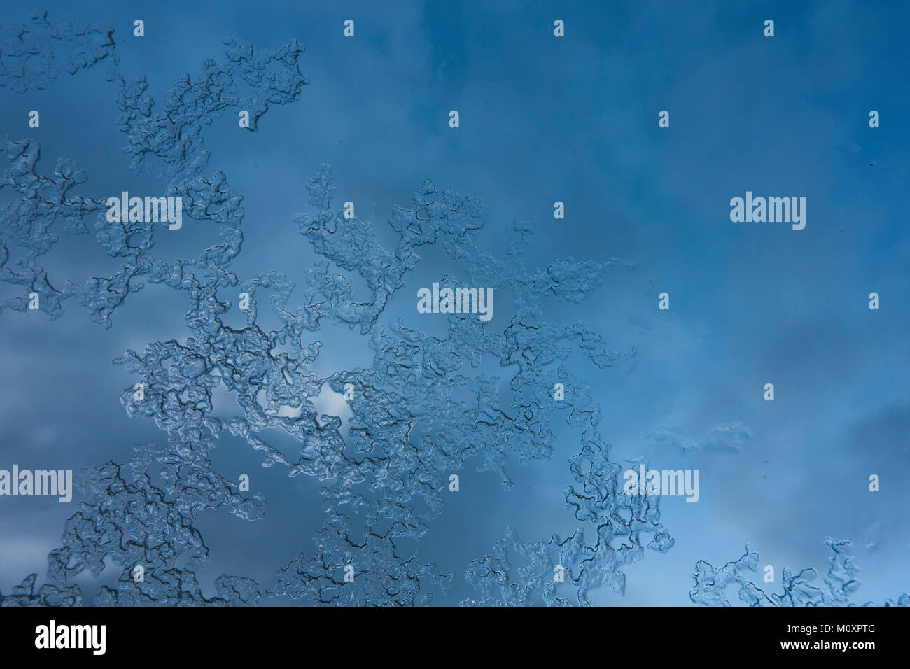 Hail and ice graupel, on glass of rooftop window after hailstorm ...
