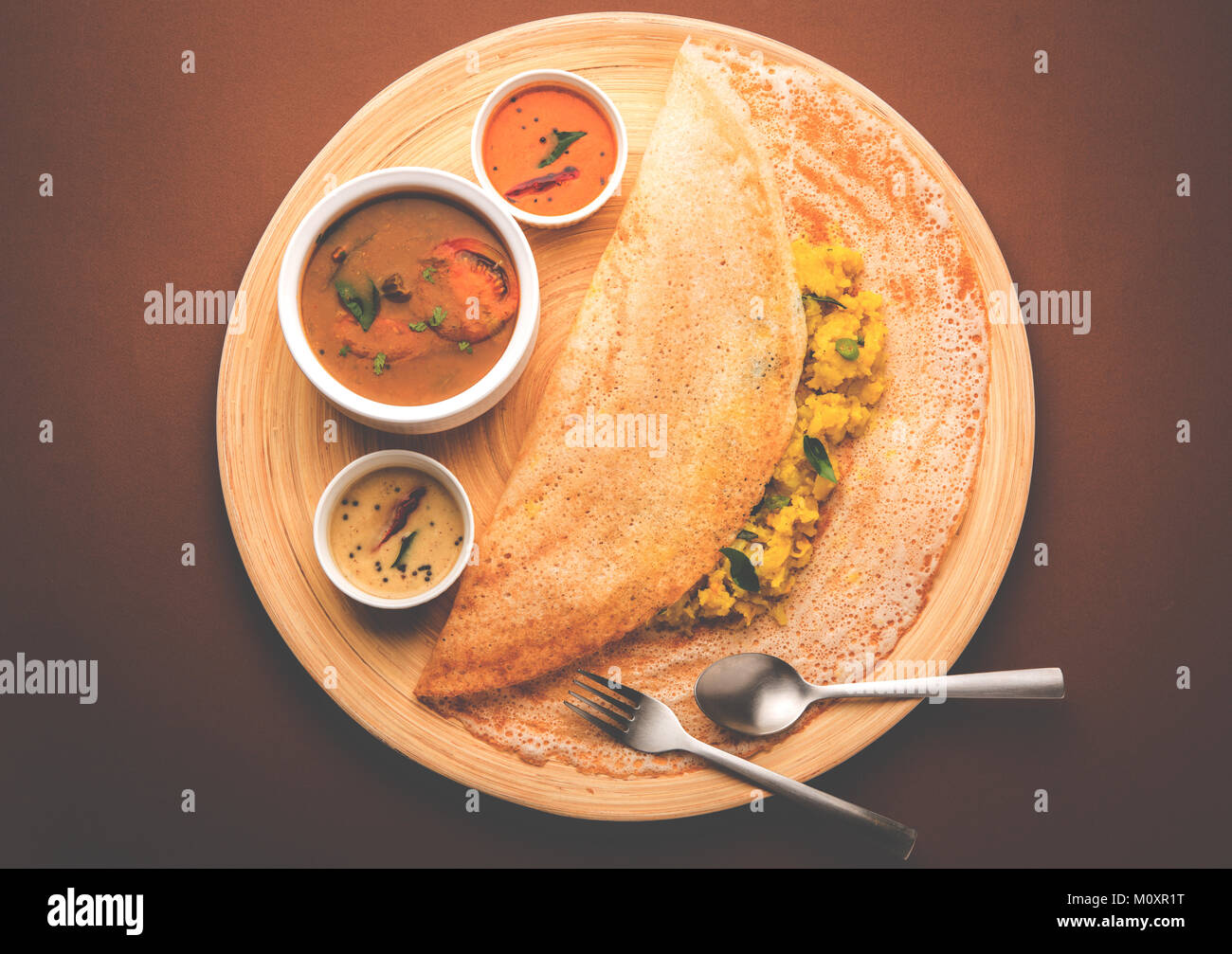Masala dosa with chutney and sambar and potato sabzi. Cone, triangle or ...