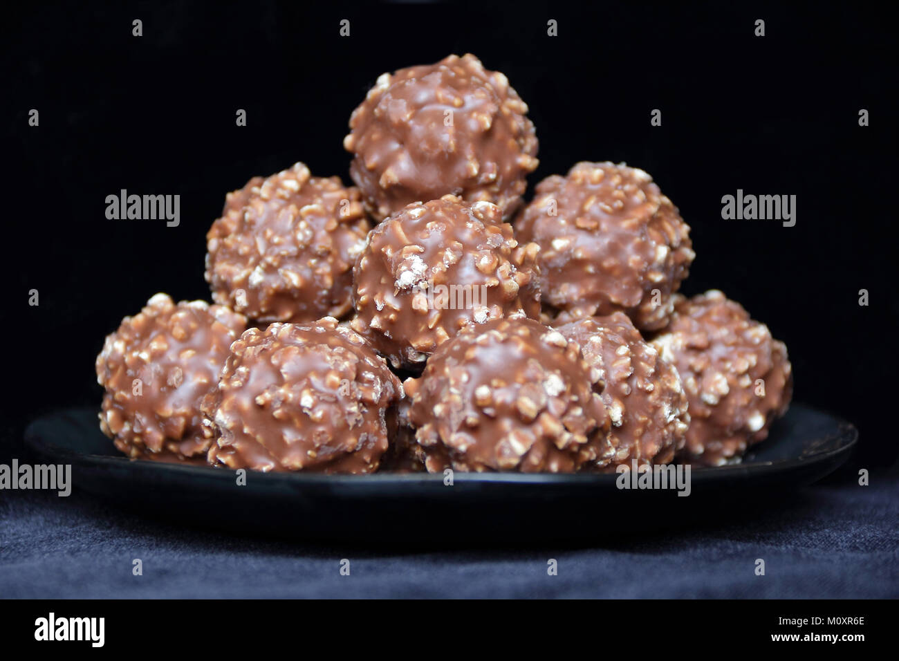 Image of brown sweet candy on black background Stock Photo - Alamy