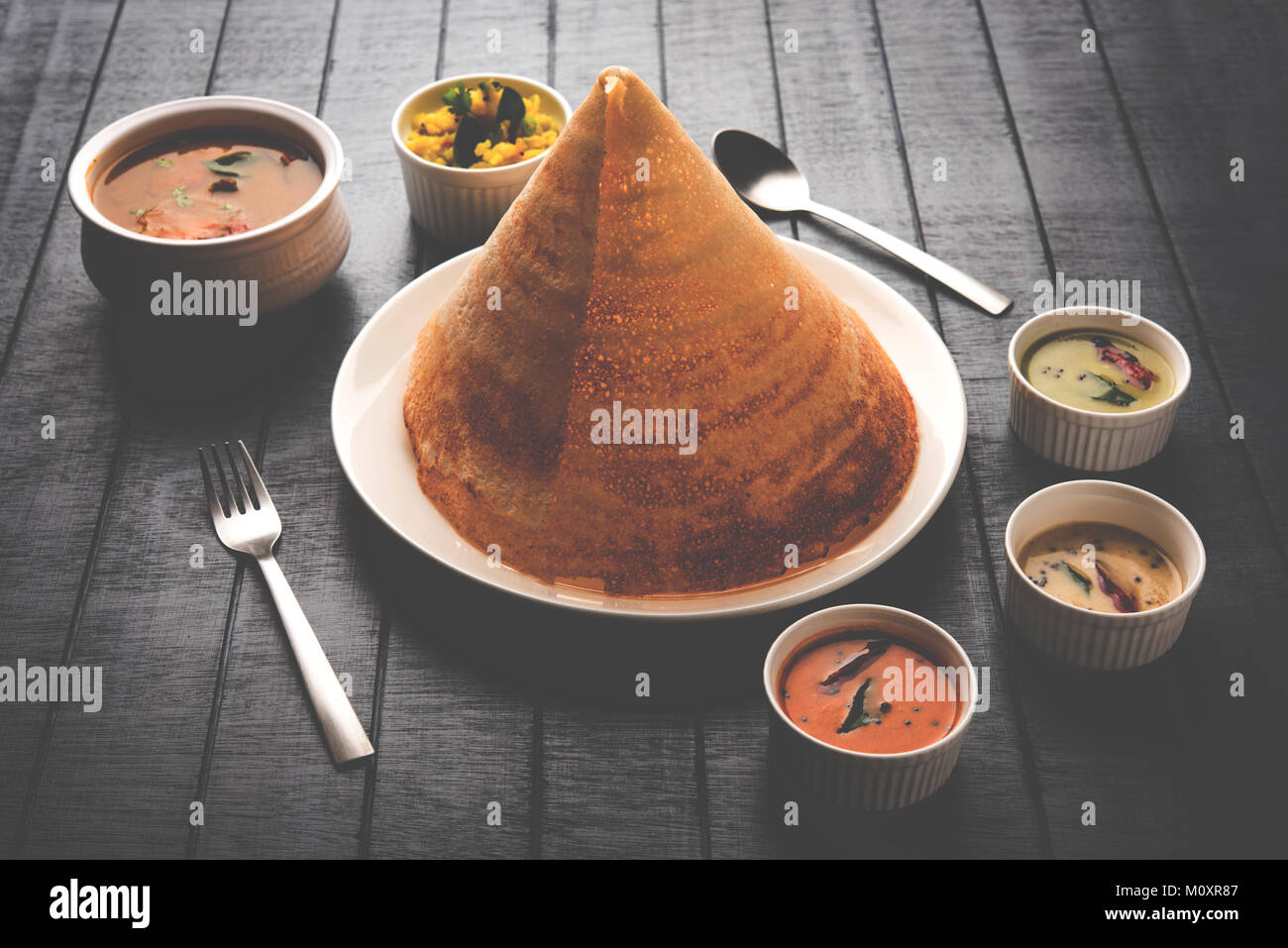 Masala dosa with chutney and sambar and potato sabzi. Cone, triangle or ...