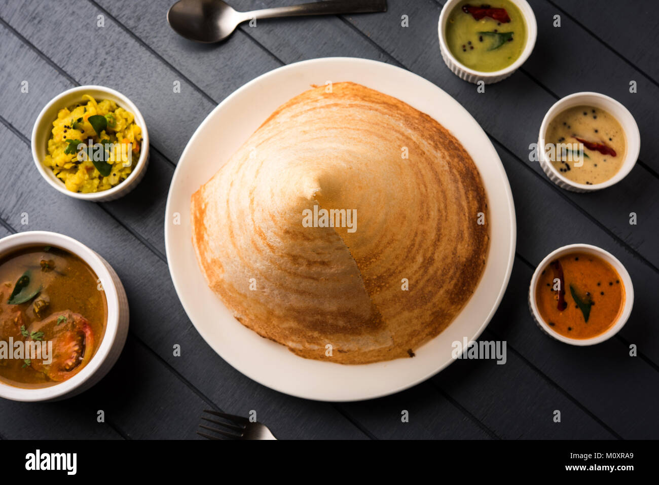 Masala dosa with chutney and sambar and potato sabzi. Cone, triangle or ...