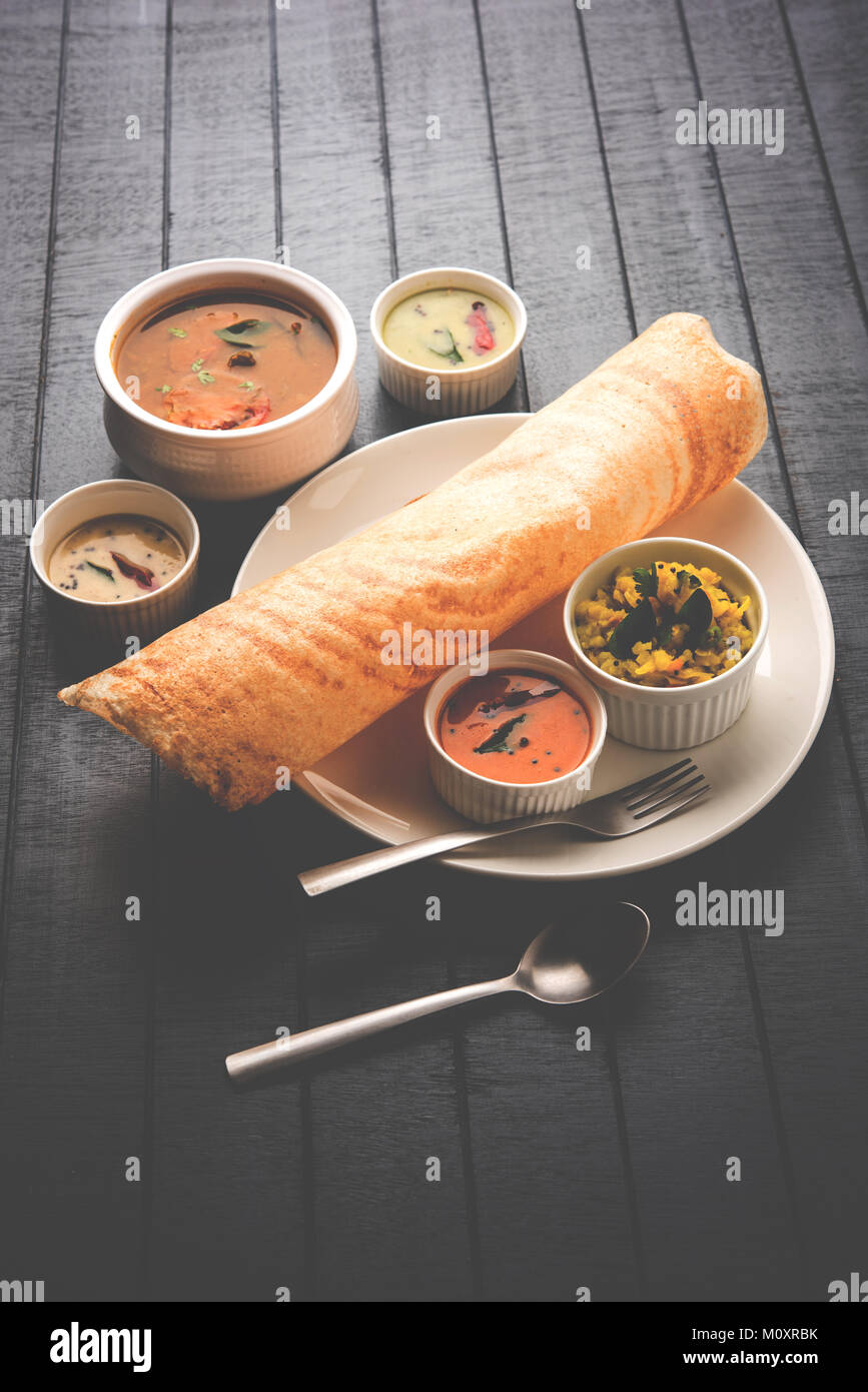 Masala dosa with chutney and sambar and potato sabzi. Cone, triangle or ...