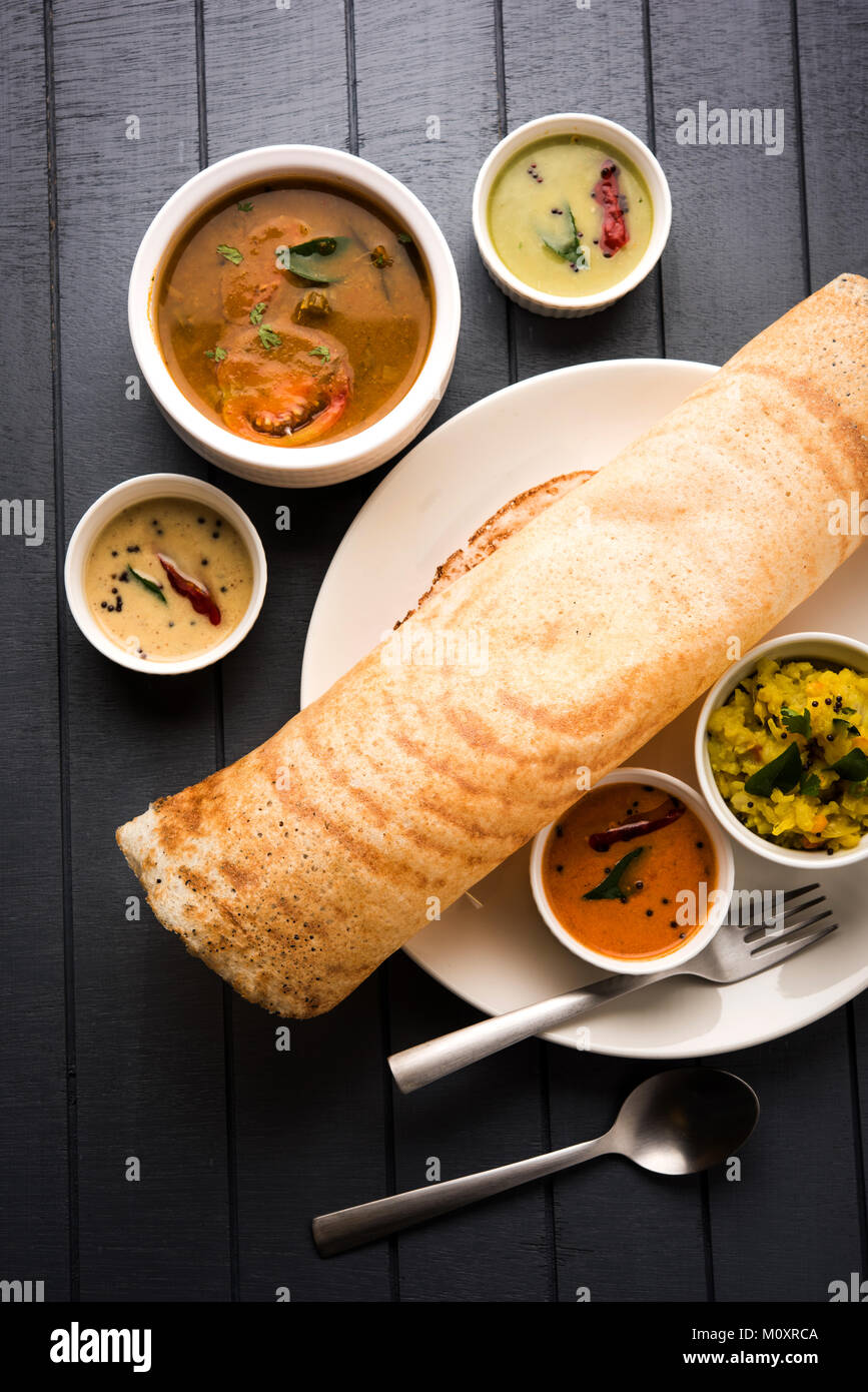 Masala dosa with chutney and sambar and potato sabzi. Cone, triangle or ...
