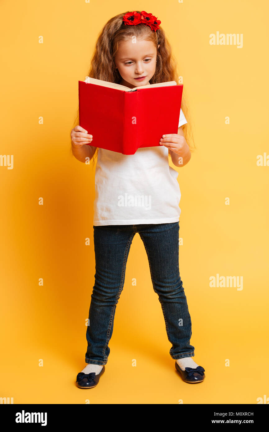 Picture of concentrated little pretty girl standing isolated over ...