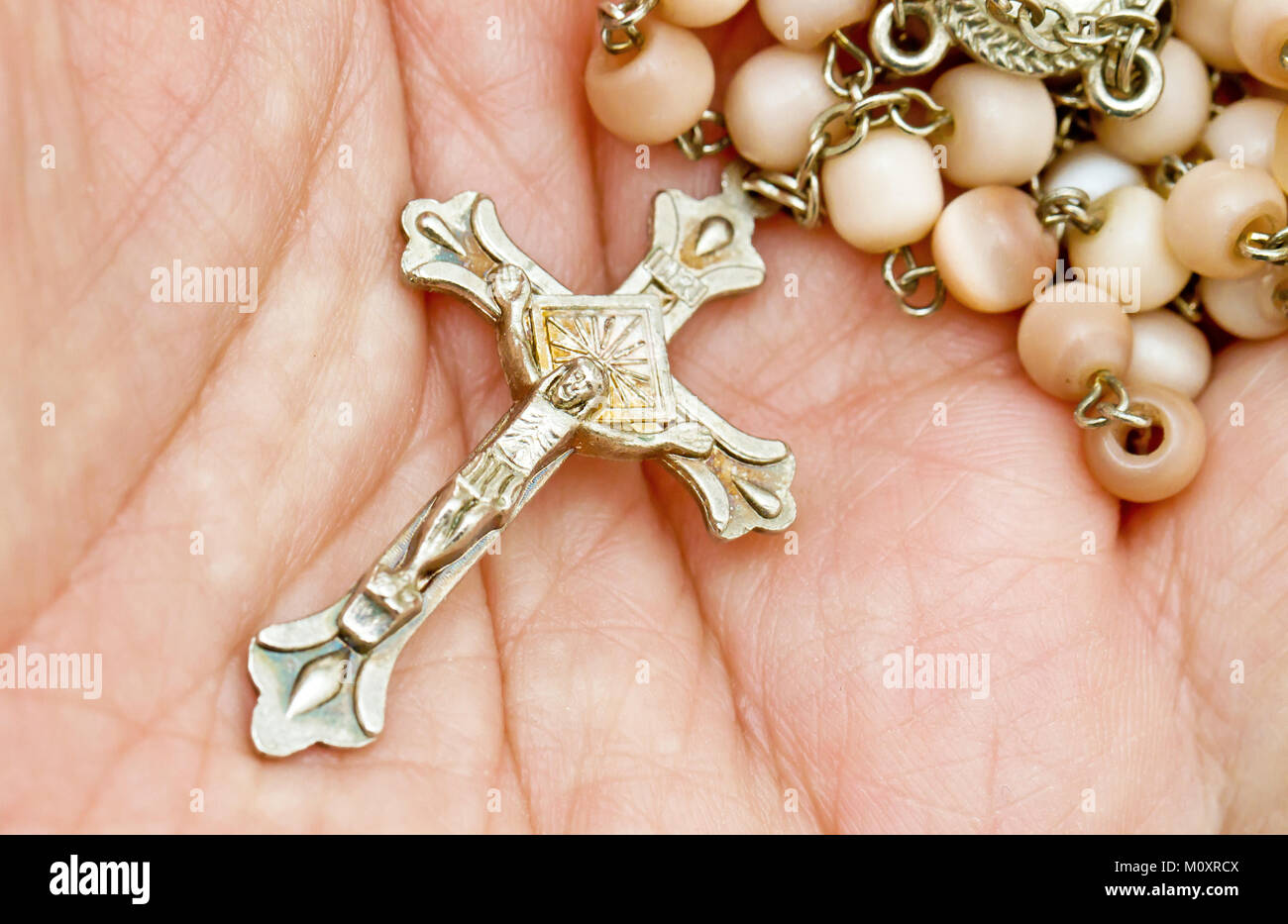 Cross in the hand Stock Photo - Alamy