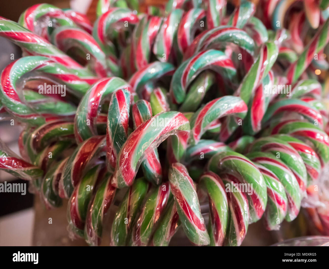 close up of a basket full of candy sticks with color stripes in a ...