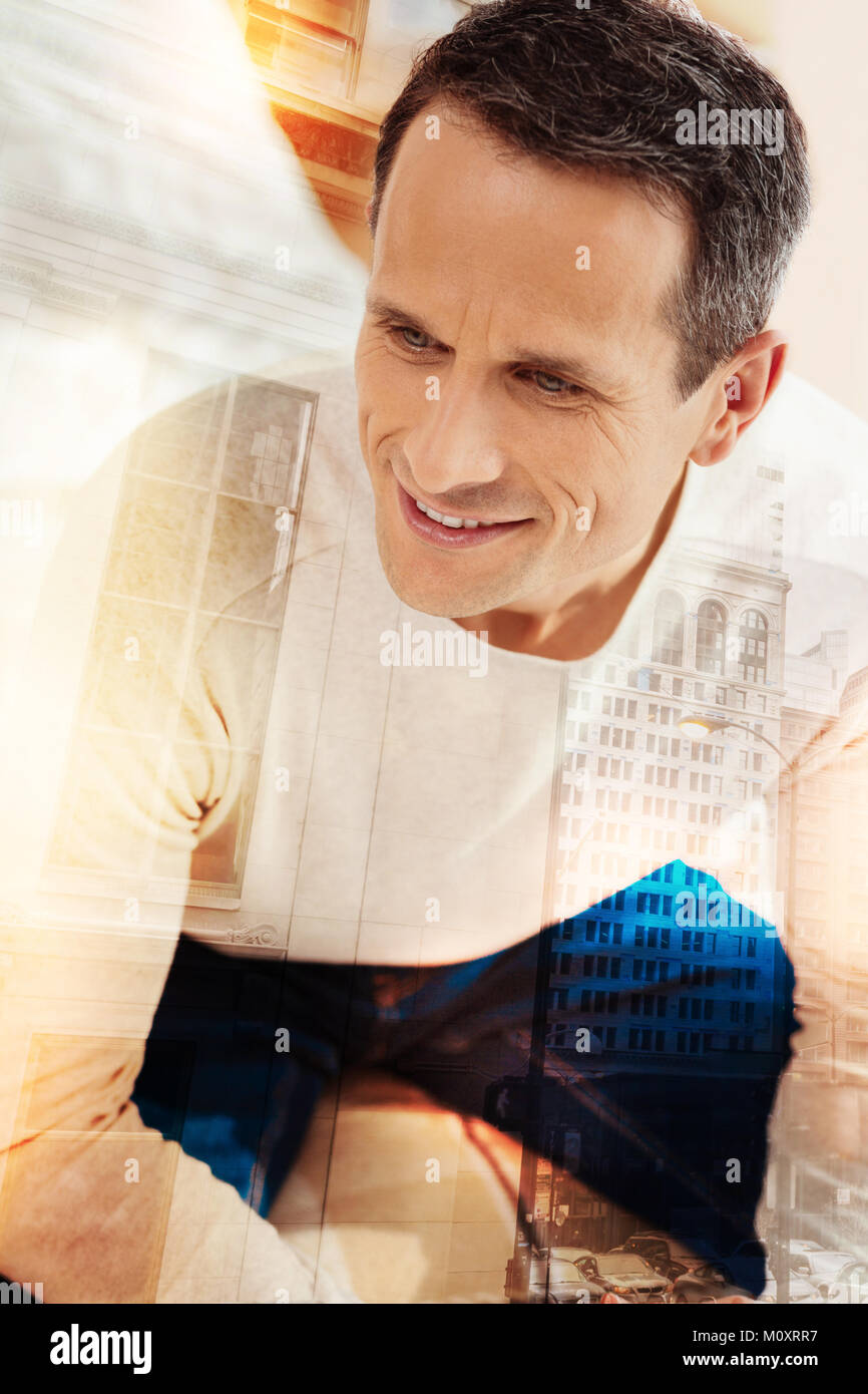 Smiling young man looking into the distance while being alone Stock ...