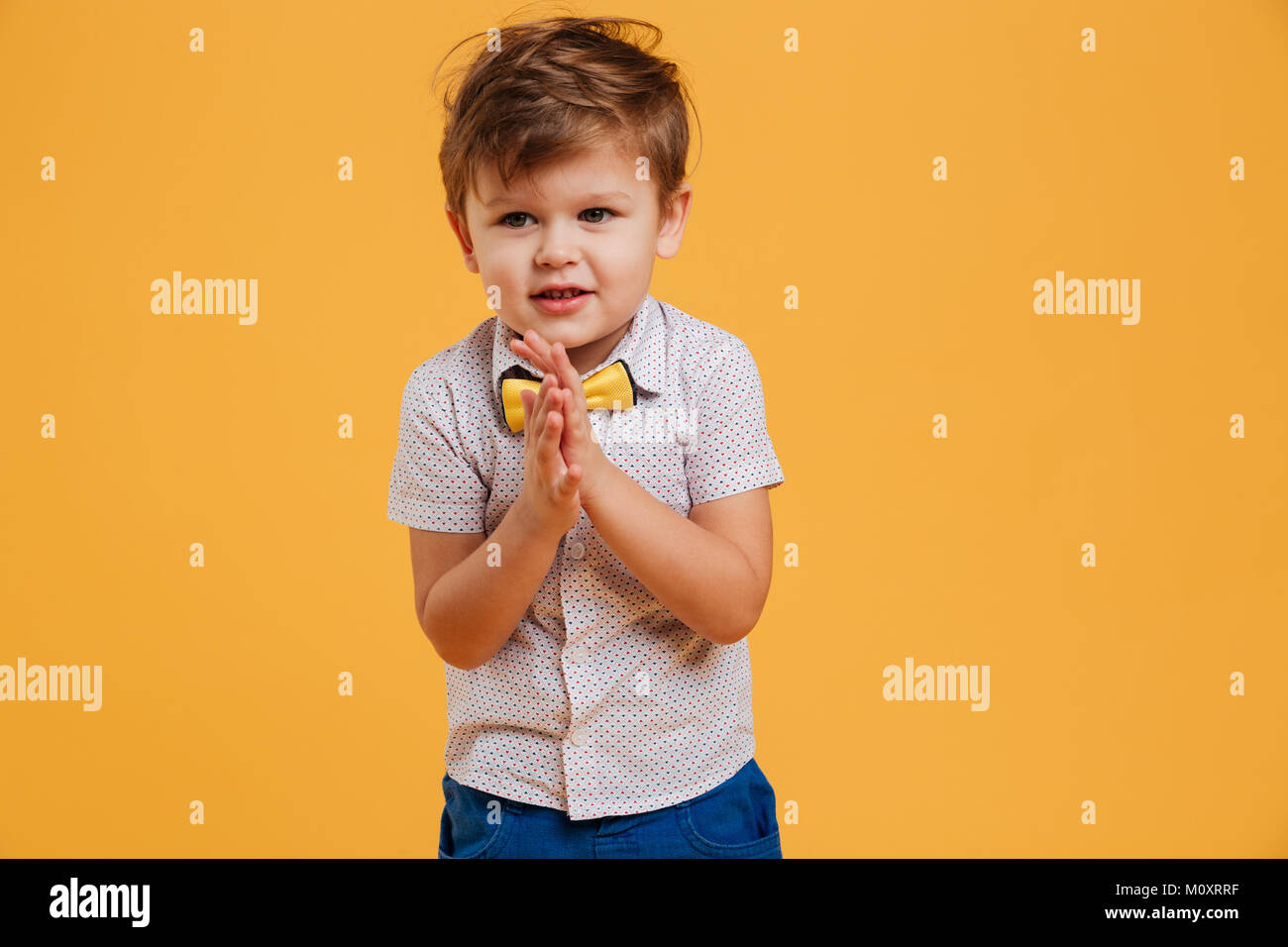 Picture of little boy child standing isolated over yellow background ...