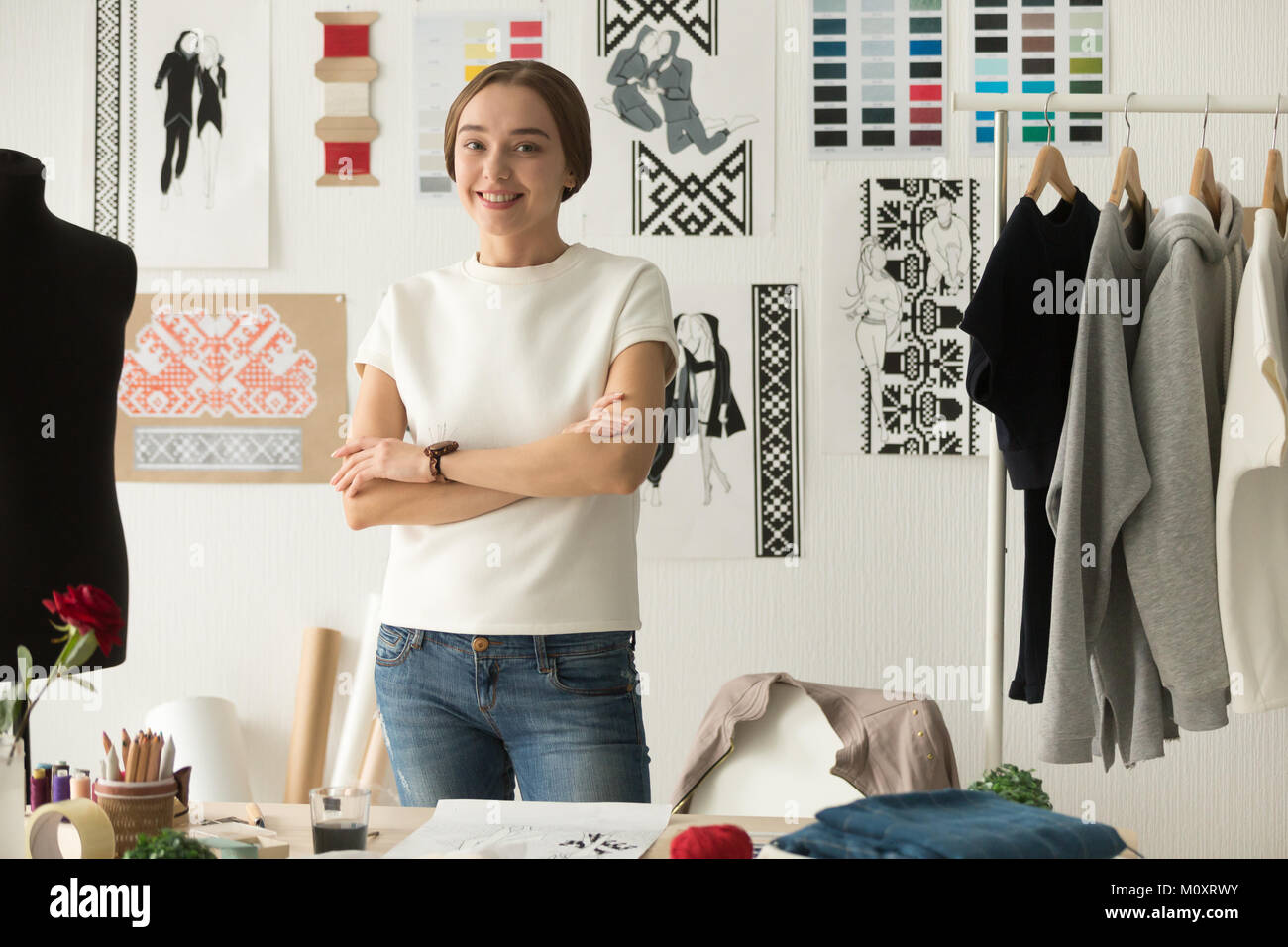 Ethnic embroidered clothing fashion designer standing looking at Stock ...