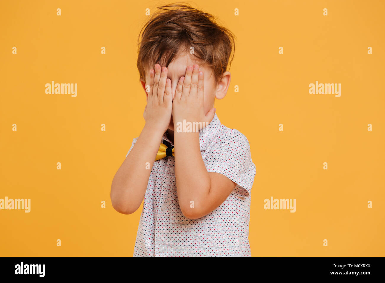 Image of little boy child standing isolated over yellow background ...