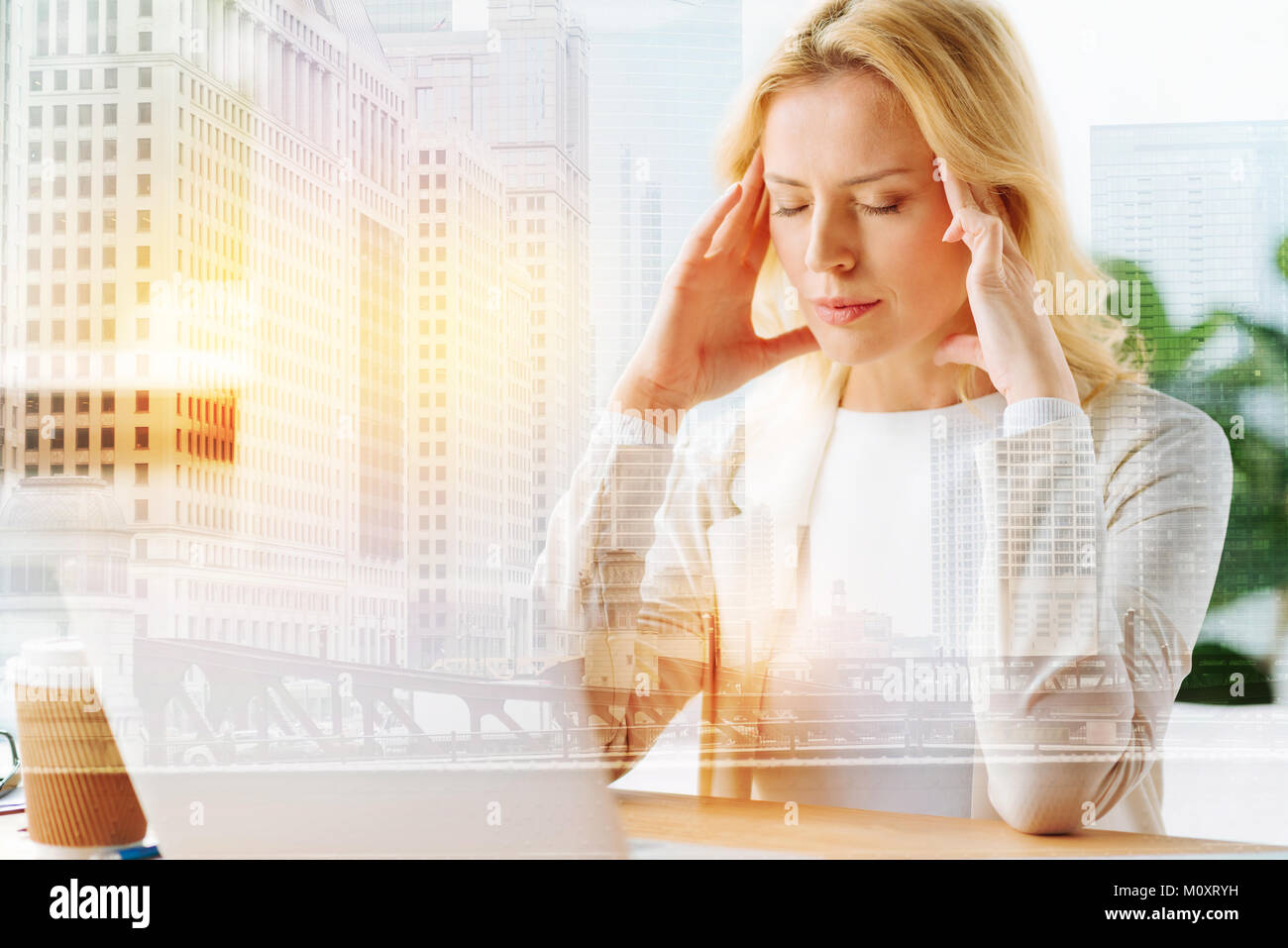 Thoughtful office manager touching her temples Stock Photo - Alamy