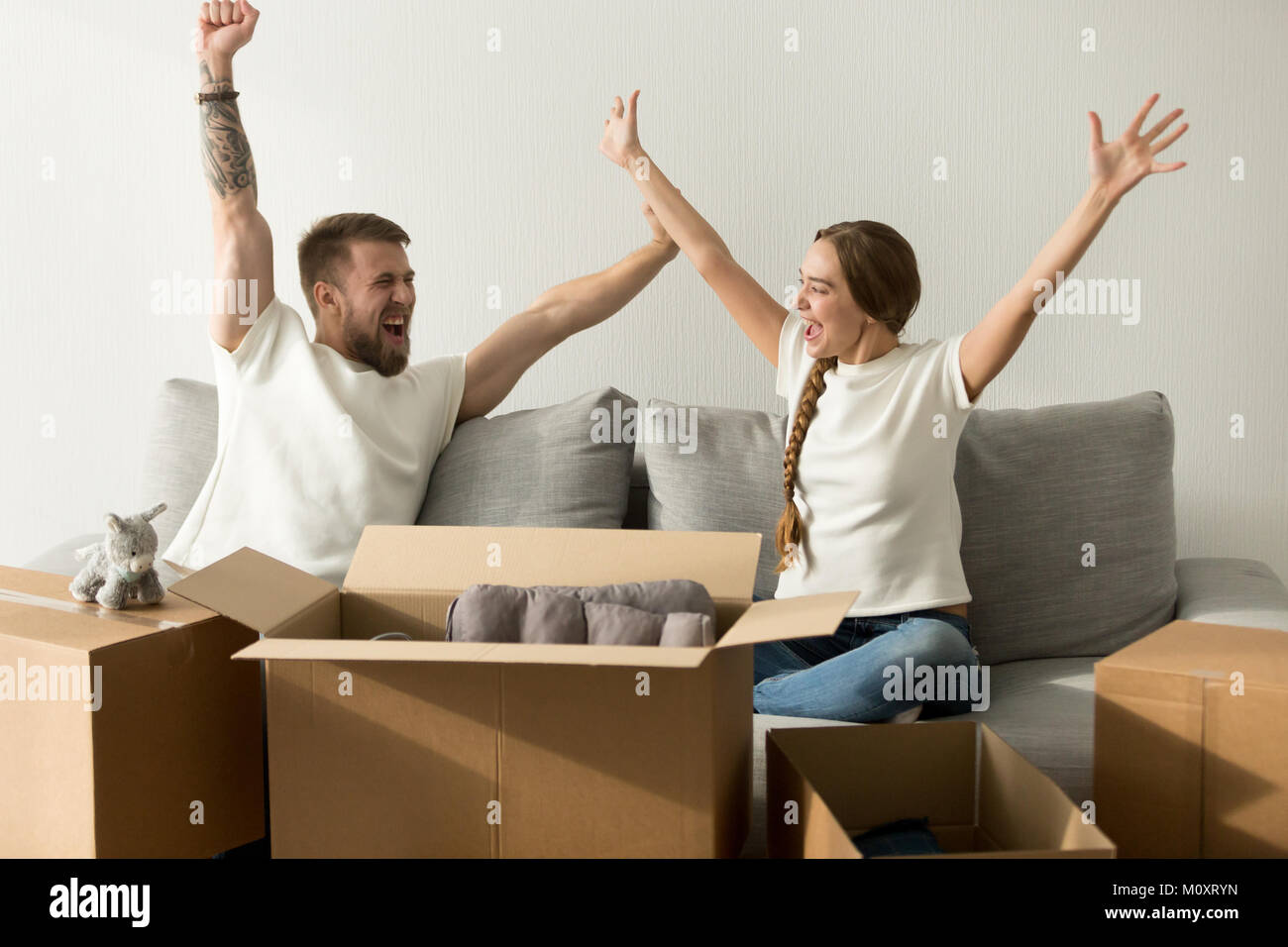 Excited couple glad to move into new home celebrating together Stock ...