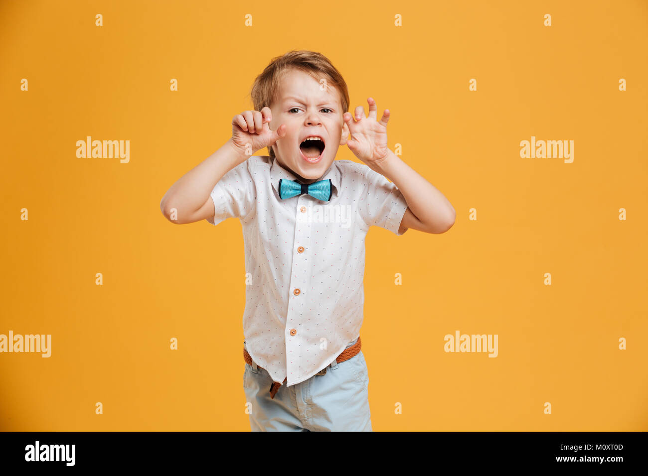Picture of emotional screaming little boy child standing isolated over ...