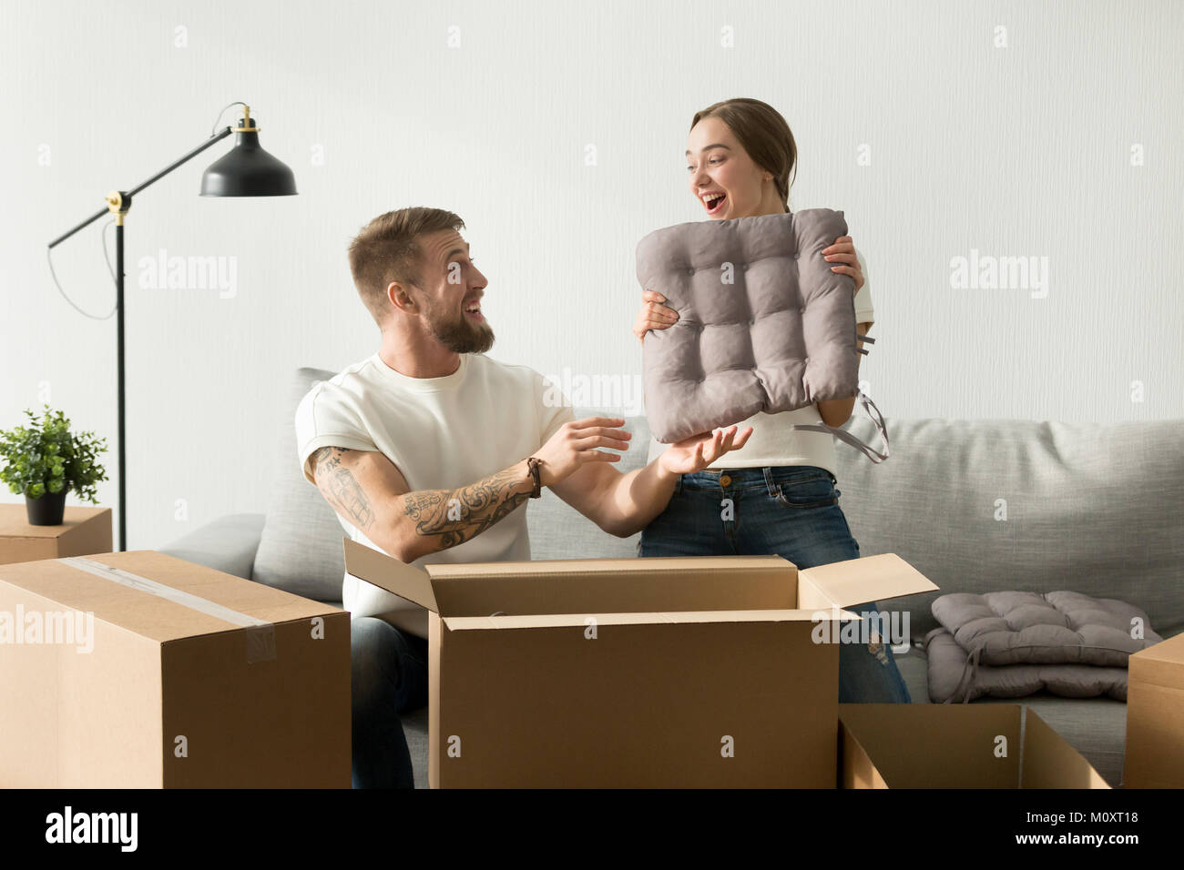 Happy couple having fun unpacking hi-res stock photography and images ...