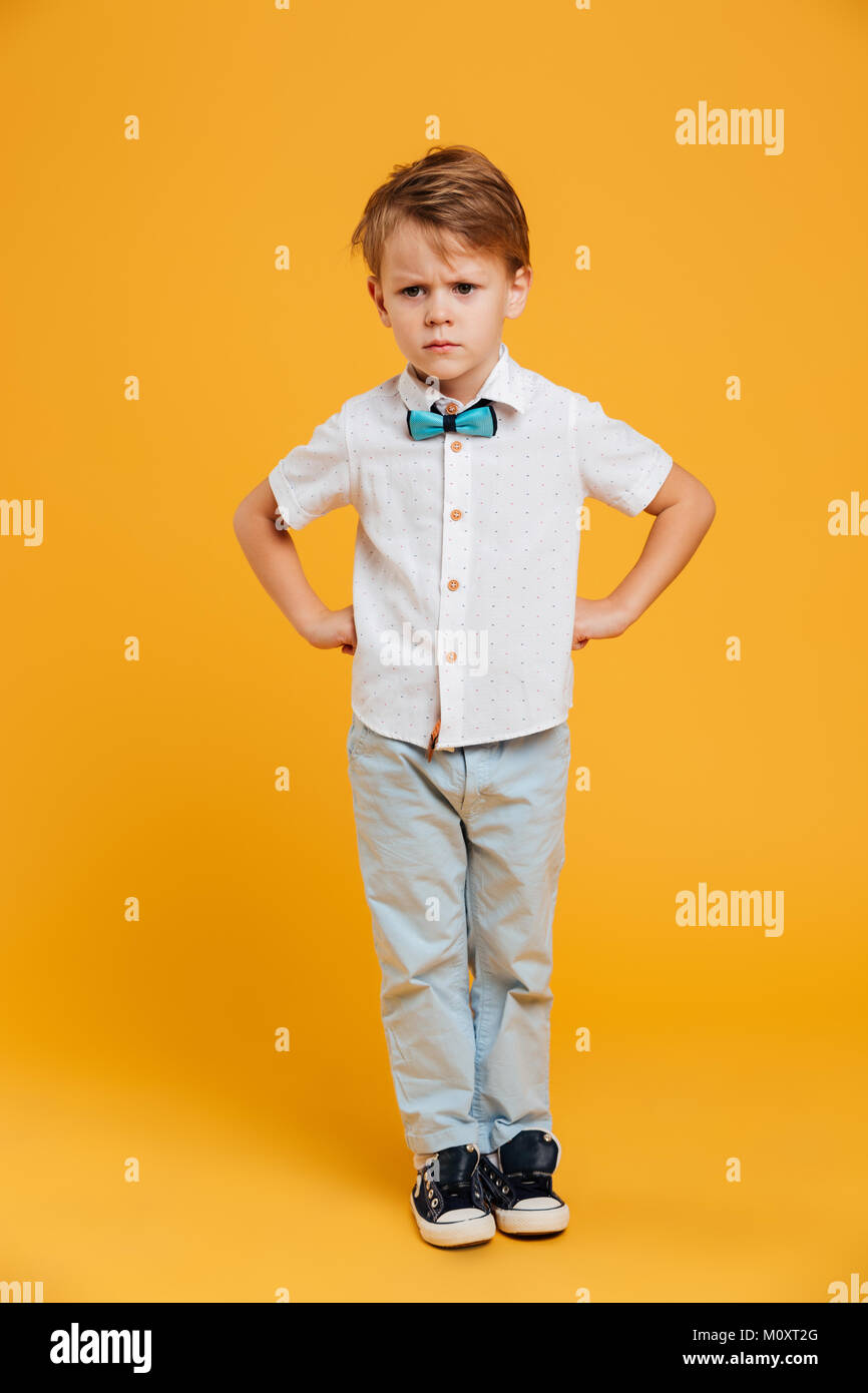 Image of displeased angry little boy child standing isolated over ...