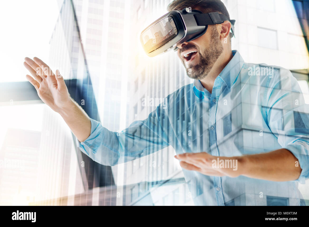 Amused man wearing virtual mask with hands kept forward Stock Photo - Alamy