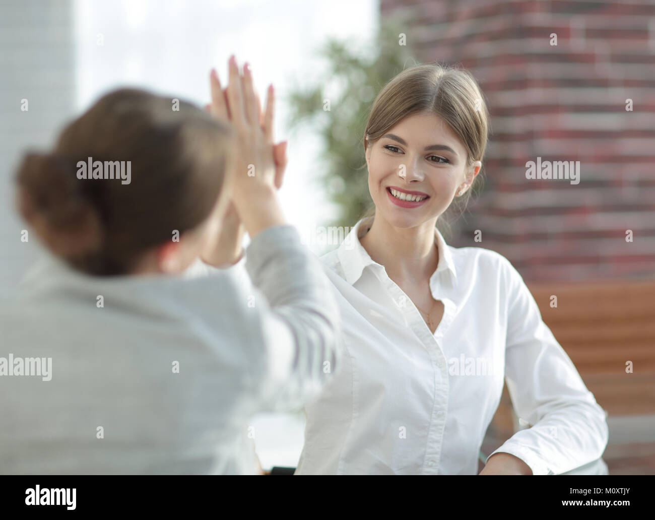 members of the business team giving each other a high five Stock Photo ...
