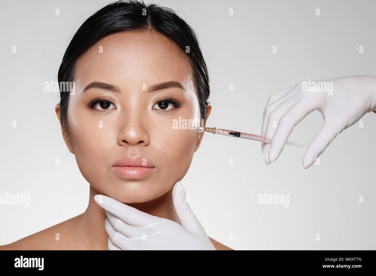 Portrait of a beautiful asian woman getting a beauty medical treatment ...