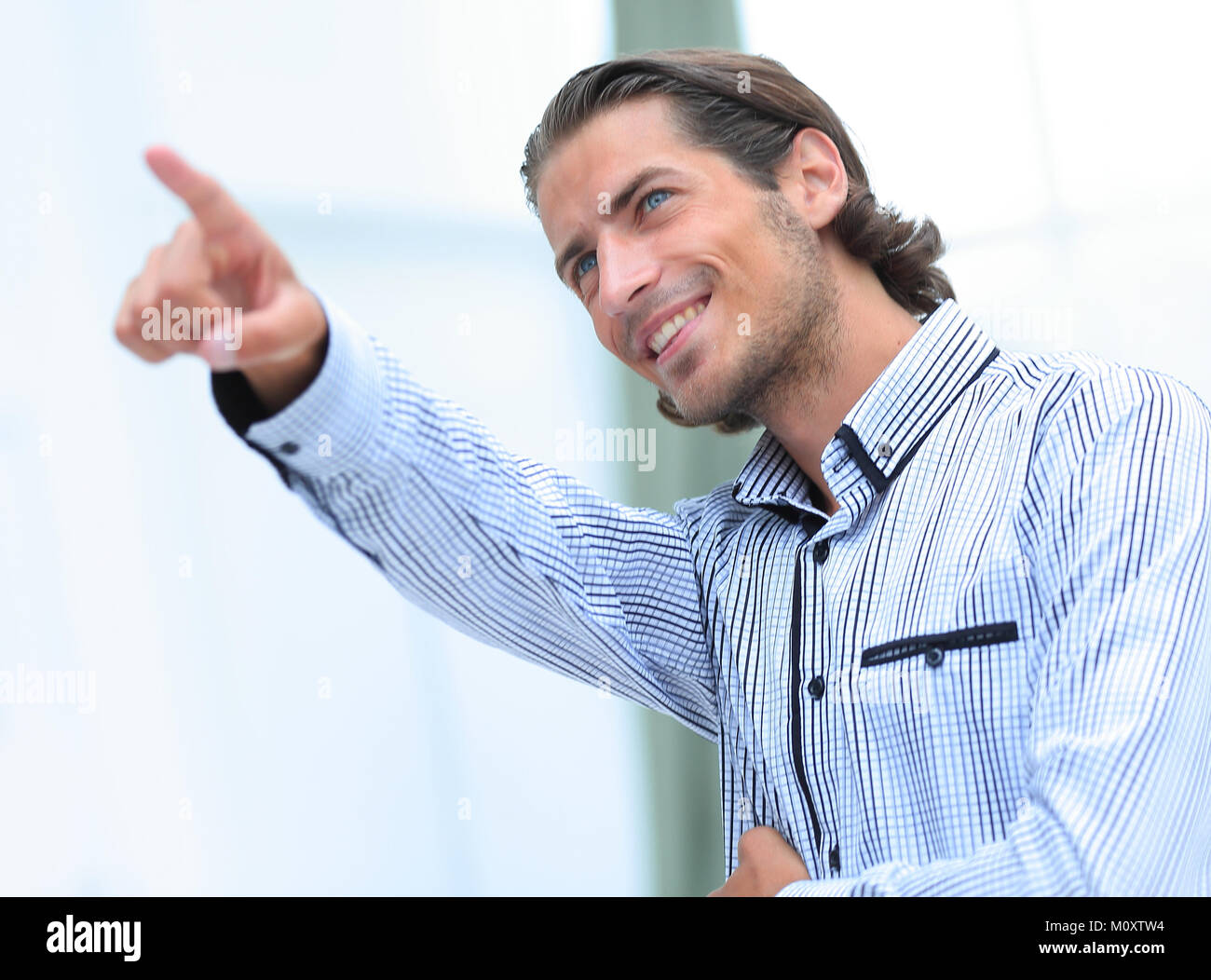 successful young man pointing forward Stock Photo - Alamy