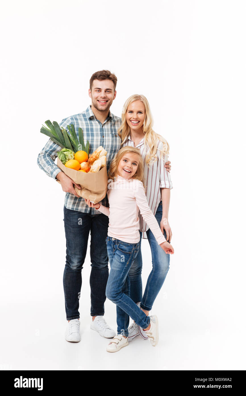 Full length portrait of a happy family holding paper shopping bag full ...