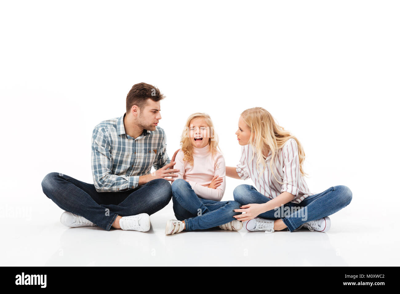 Portrait of a angry family sitting together and having an argument ...