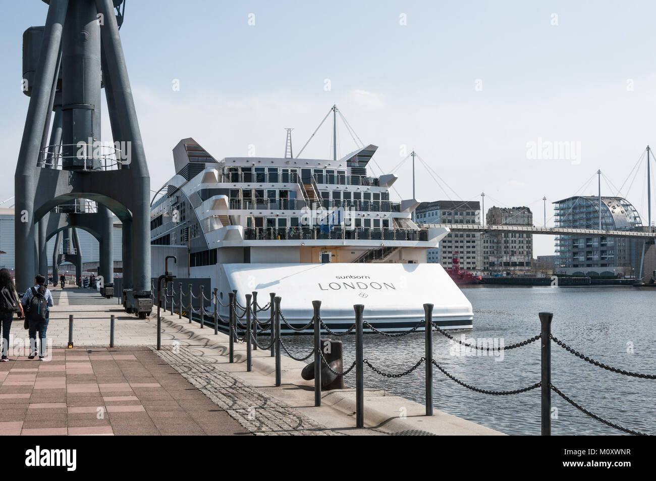 People strolling along the quayside at the Royal Victoria Dock, East ...