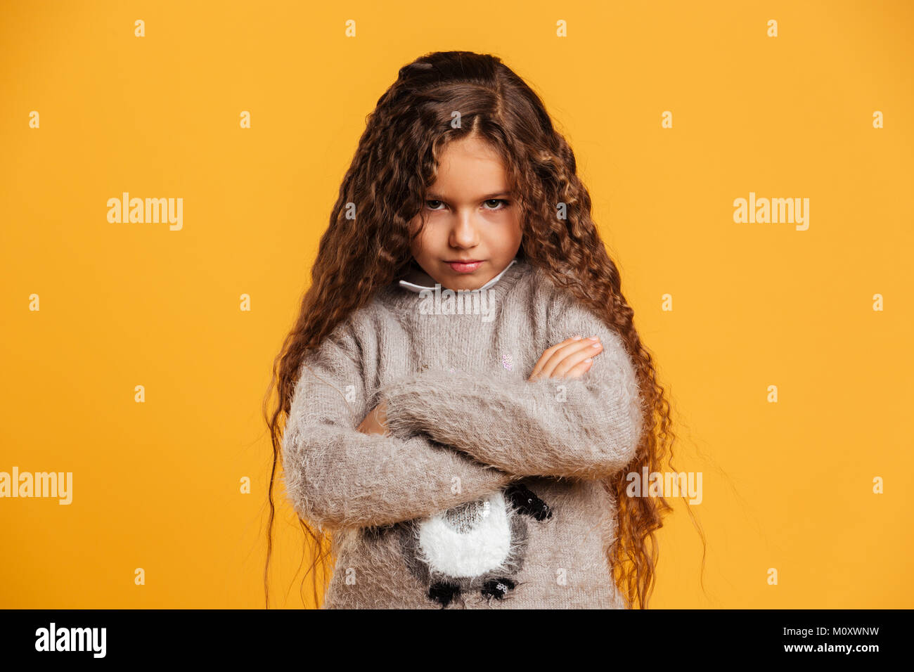 Picture of angry little girl child standing isolated over yellow ...