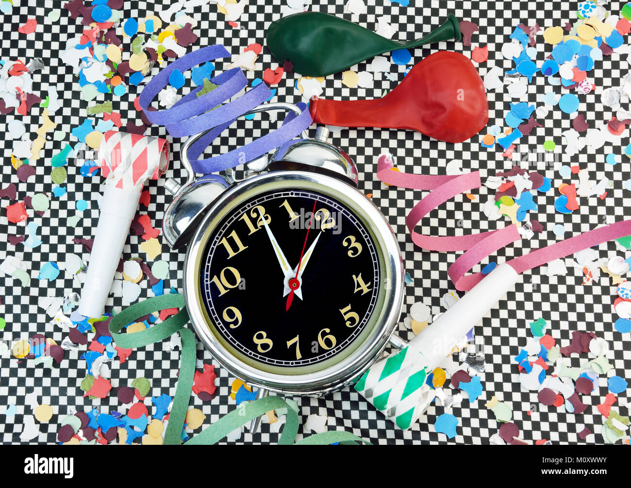 Party time concept with an alarm clock, streamers , balloons and ...
