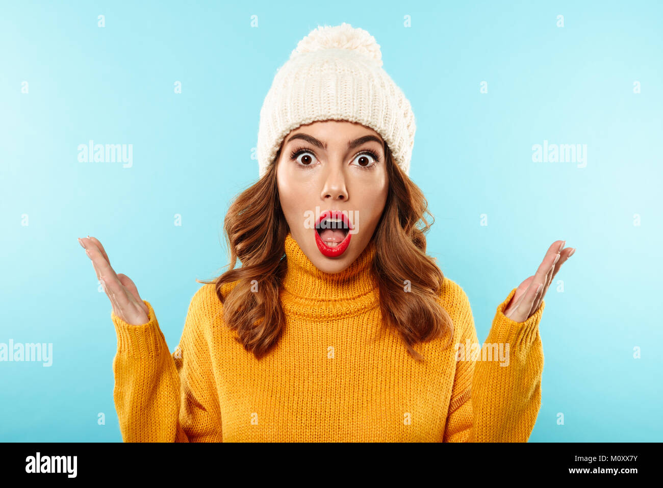 Close up portrait of a shocked pretty girl dressed in winter clothes ...