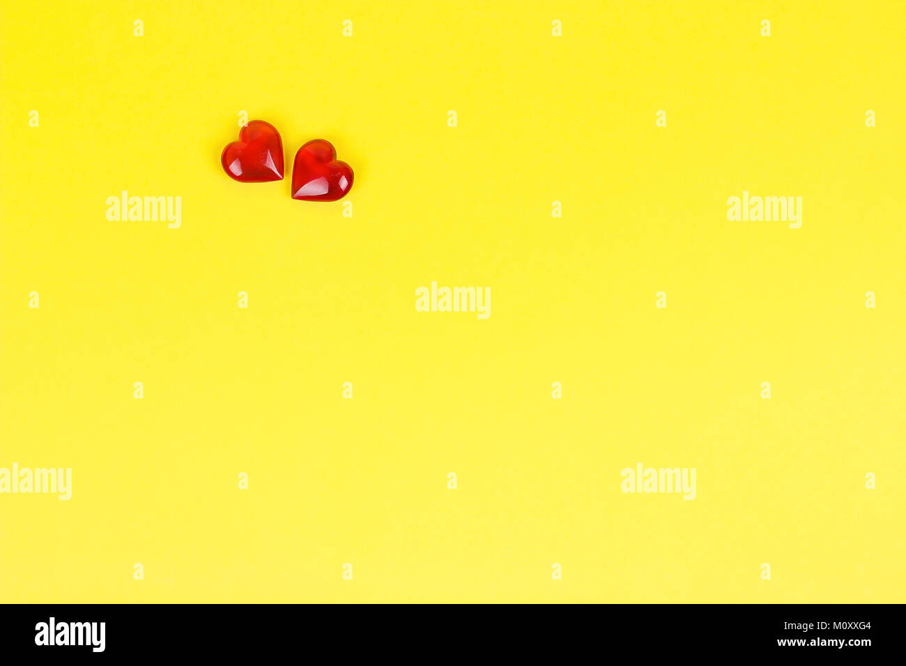 Two yellow hearts on a yellow cardboard background Stock Photo - Alamy