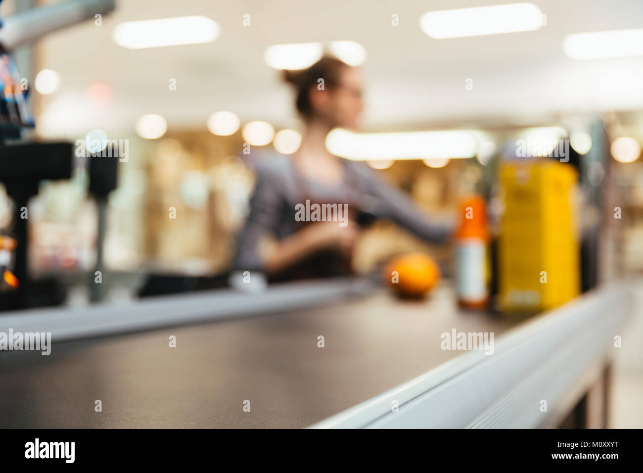 Young female cashier scanning grocery items at supermarket Stock Photo ...