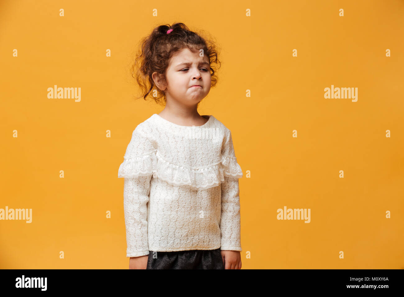 Photo of sad little girl child cry standing isolated over yellow ...