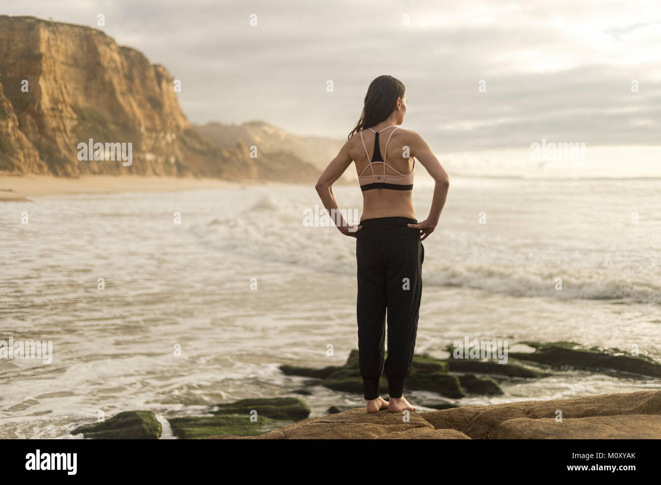 Woman standing watching sea hi-res stock photography and images - Alamy