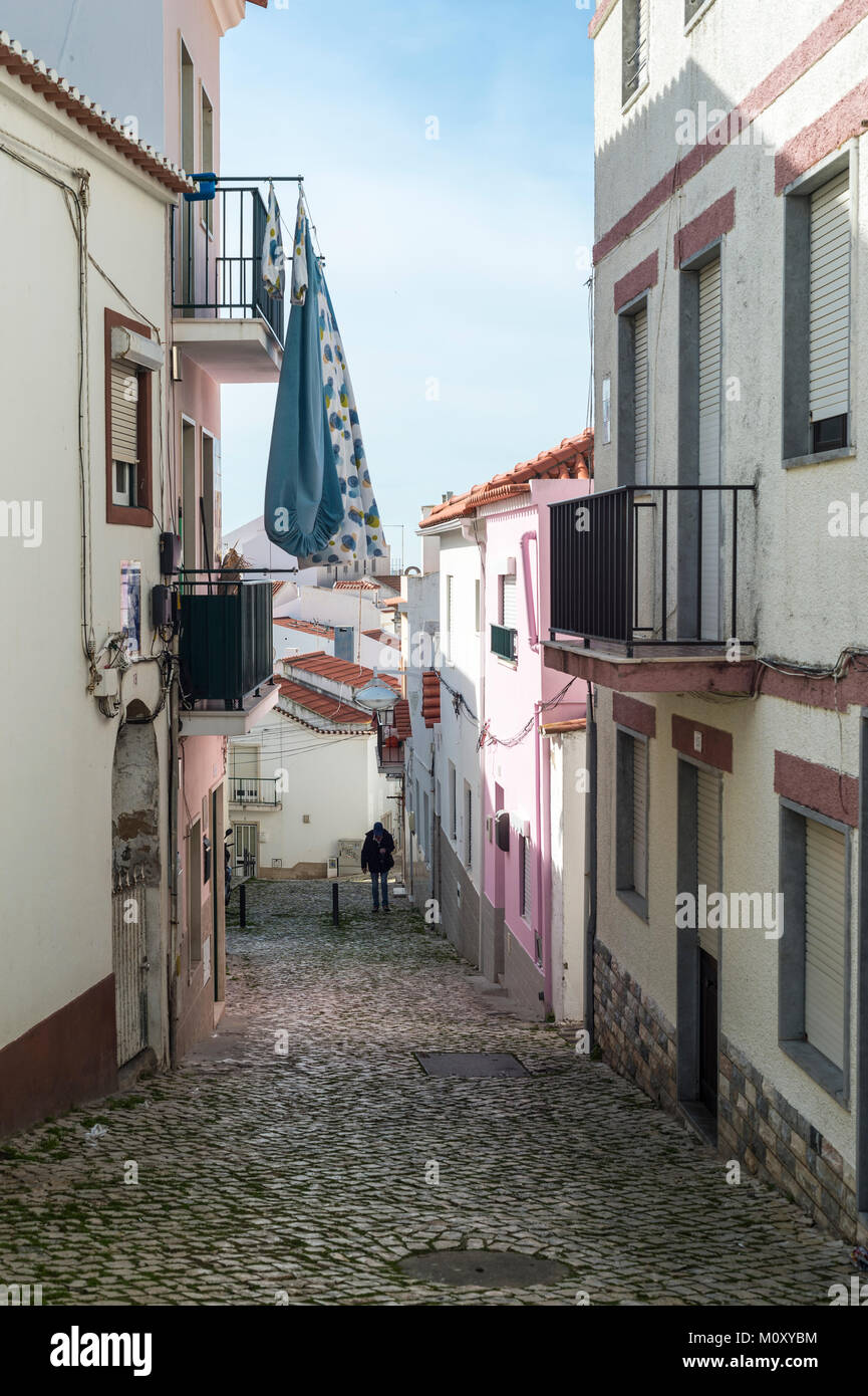 typical narrow cobblestone street in Nazare, Portugal Stock Photo - Alamy