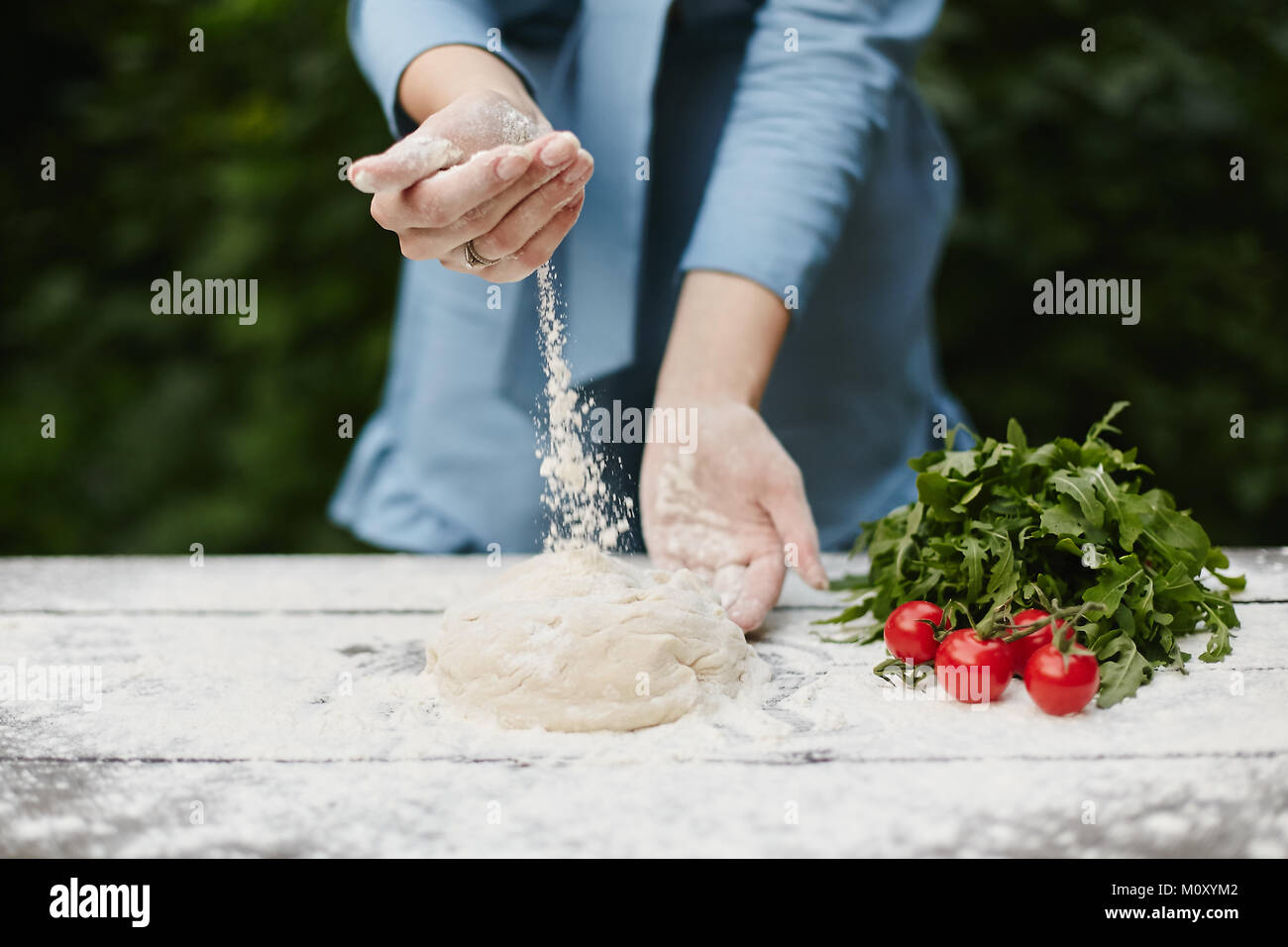 Woman cooking pizza only hands in frame Stock Photo - Alamy