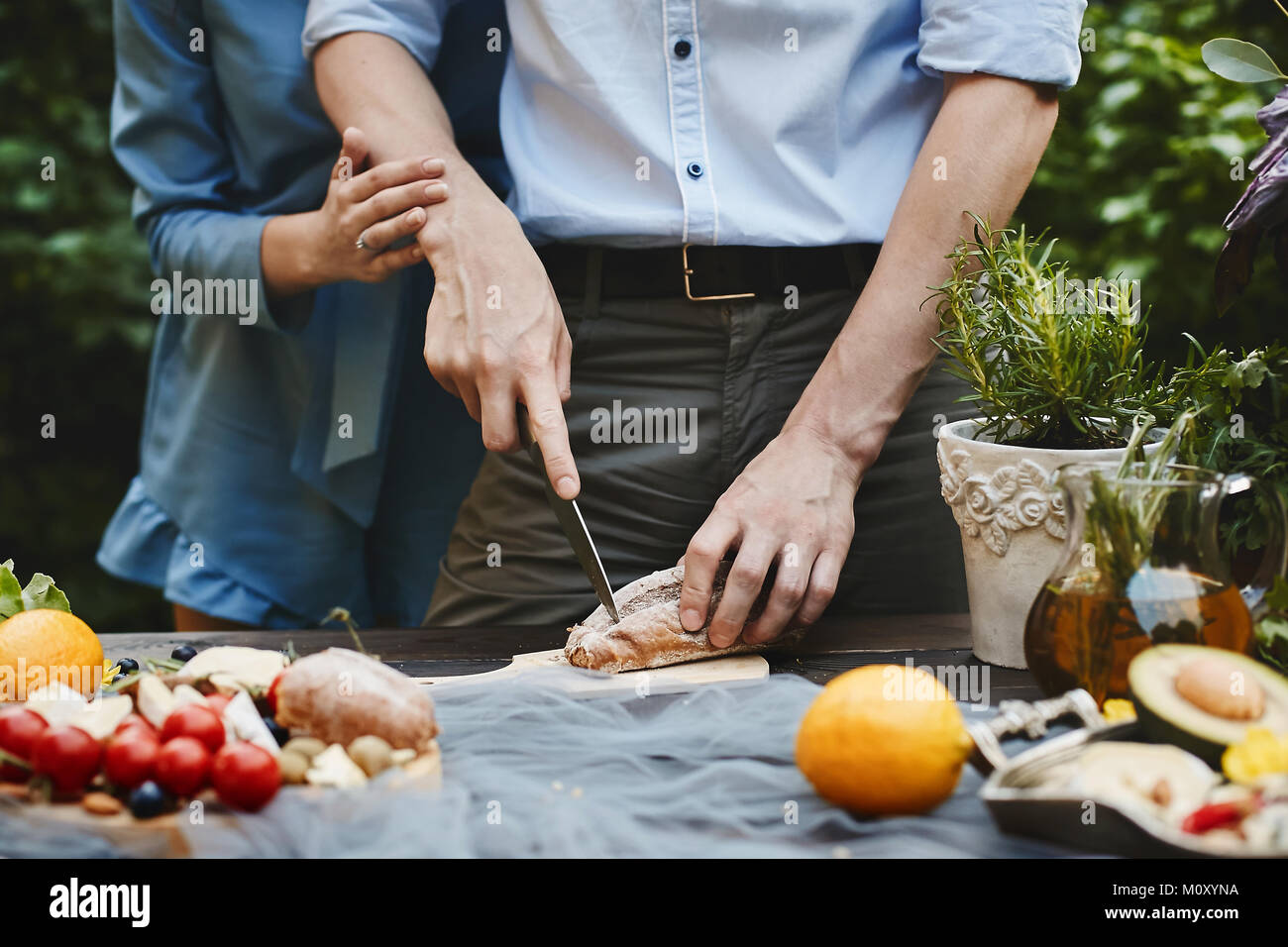 Man cuts bread in kitchen hi-res stock photography and images - Alamy