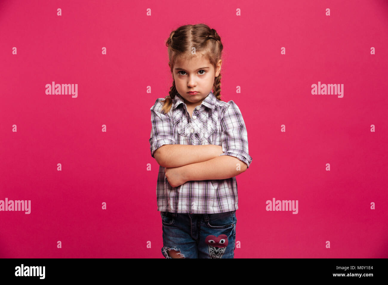 Photo of angry little girl child standing isolated over pink background ...