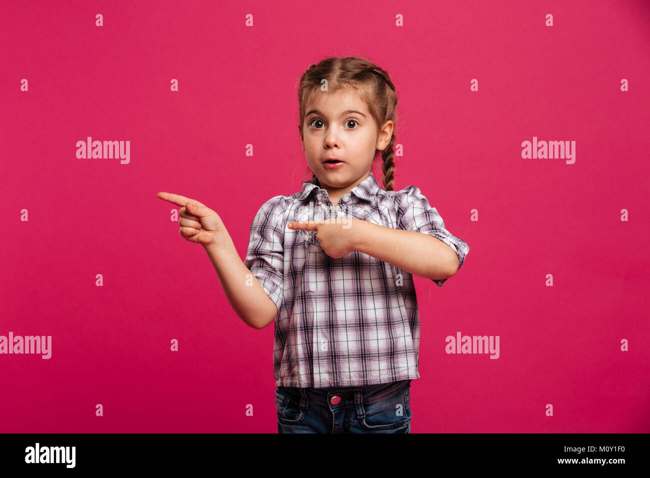 Image of surprised cute little girl child standing isolated over pink ...