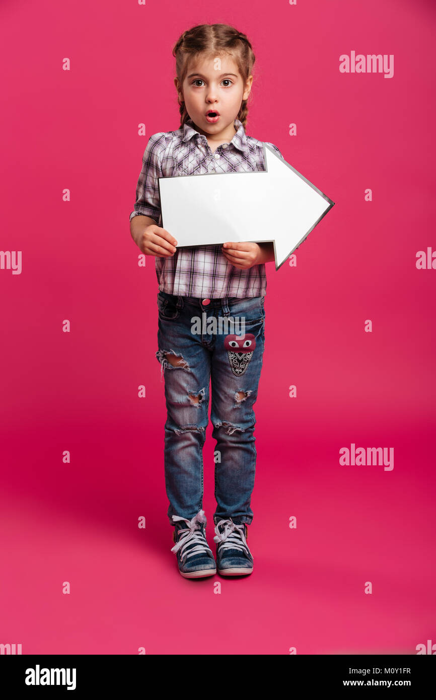 Photo of shocked little girl child standing isolated over pink ...