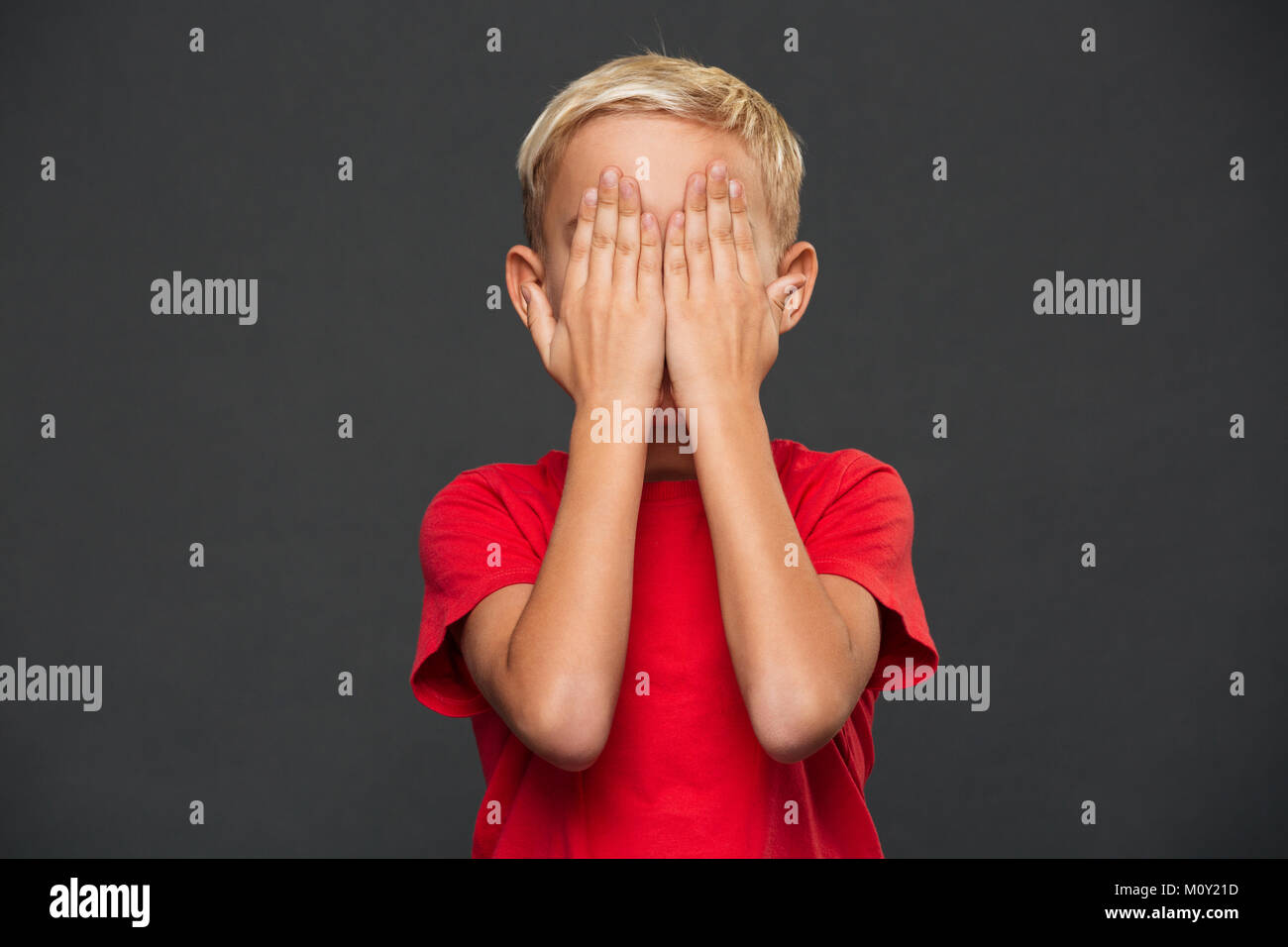 Picture of little boy child standing isolated over grey background ...