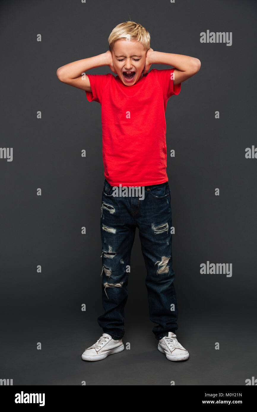 Picture of screaming little boy child standing isolated over grey ...