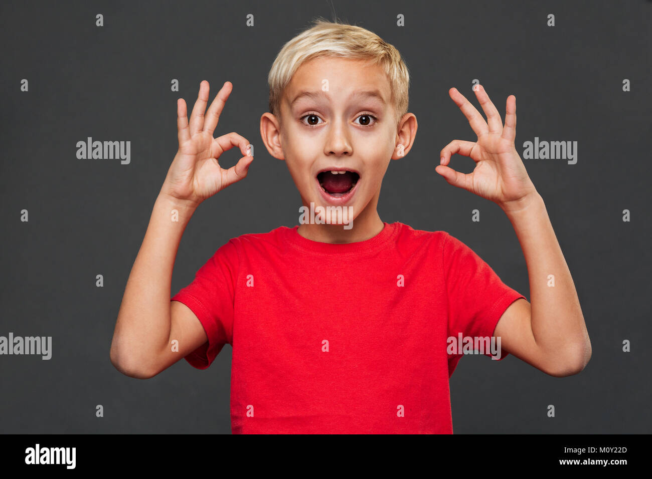Image of smiling little boy child standing isolated over grey ...