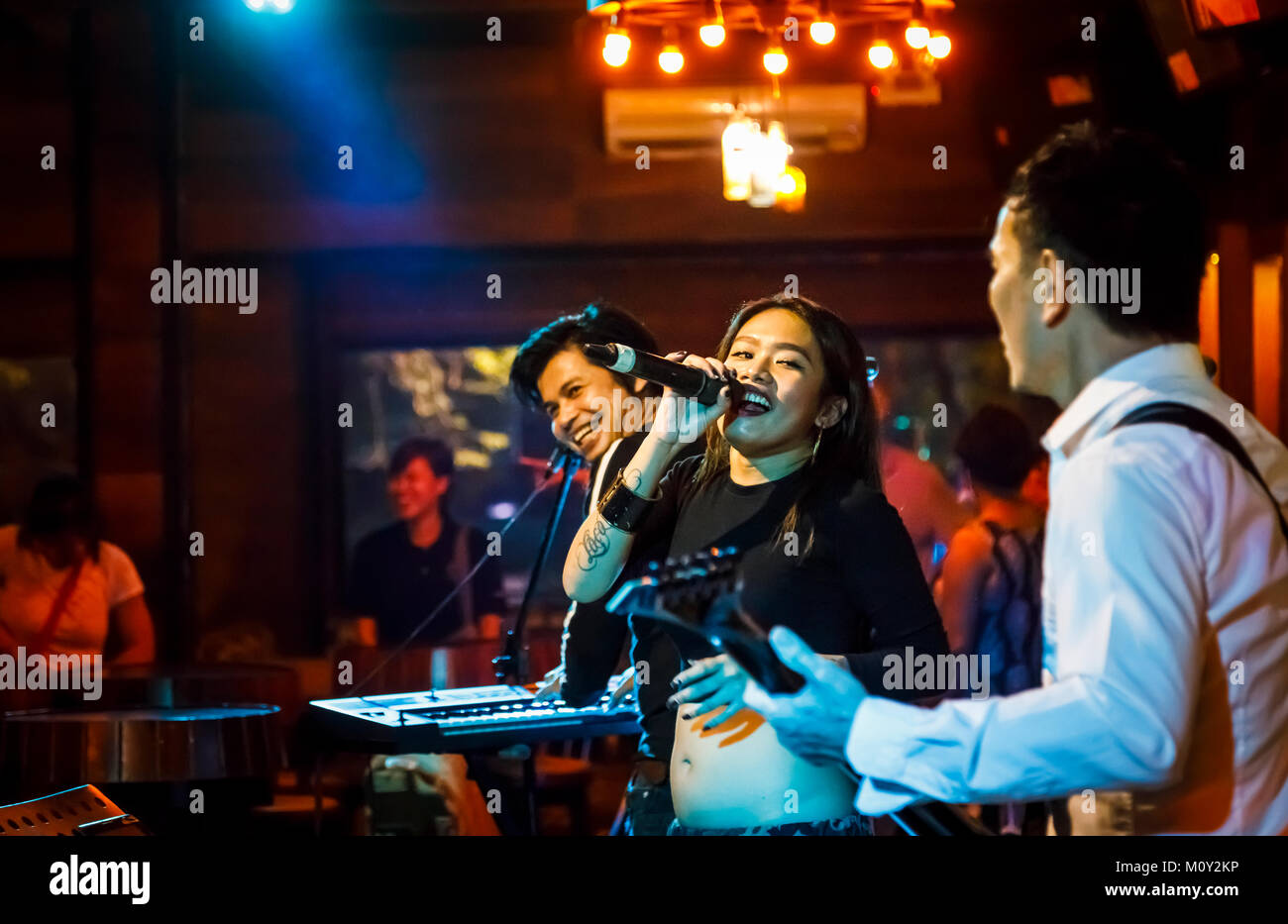 Female lead singer of a local live rock band singing at Woodstock, a ...