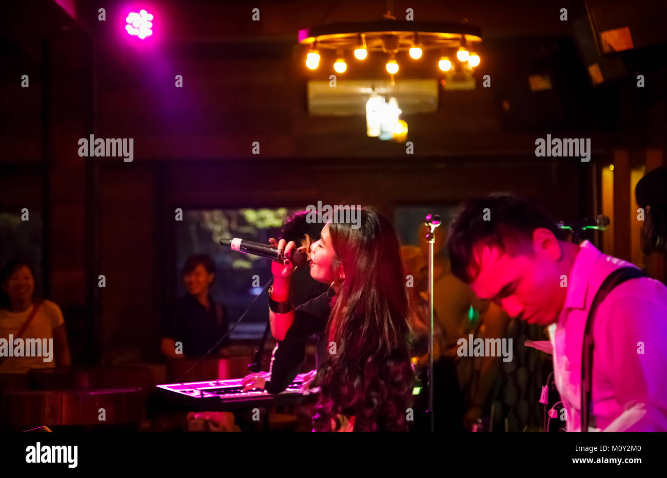 Female lead singer of a local live rock band singing at Woodstock, a ...
