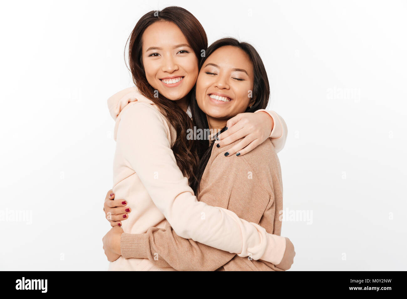 Asian sisters hugging hi-res stock photography and images - Alamy