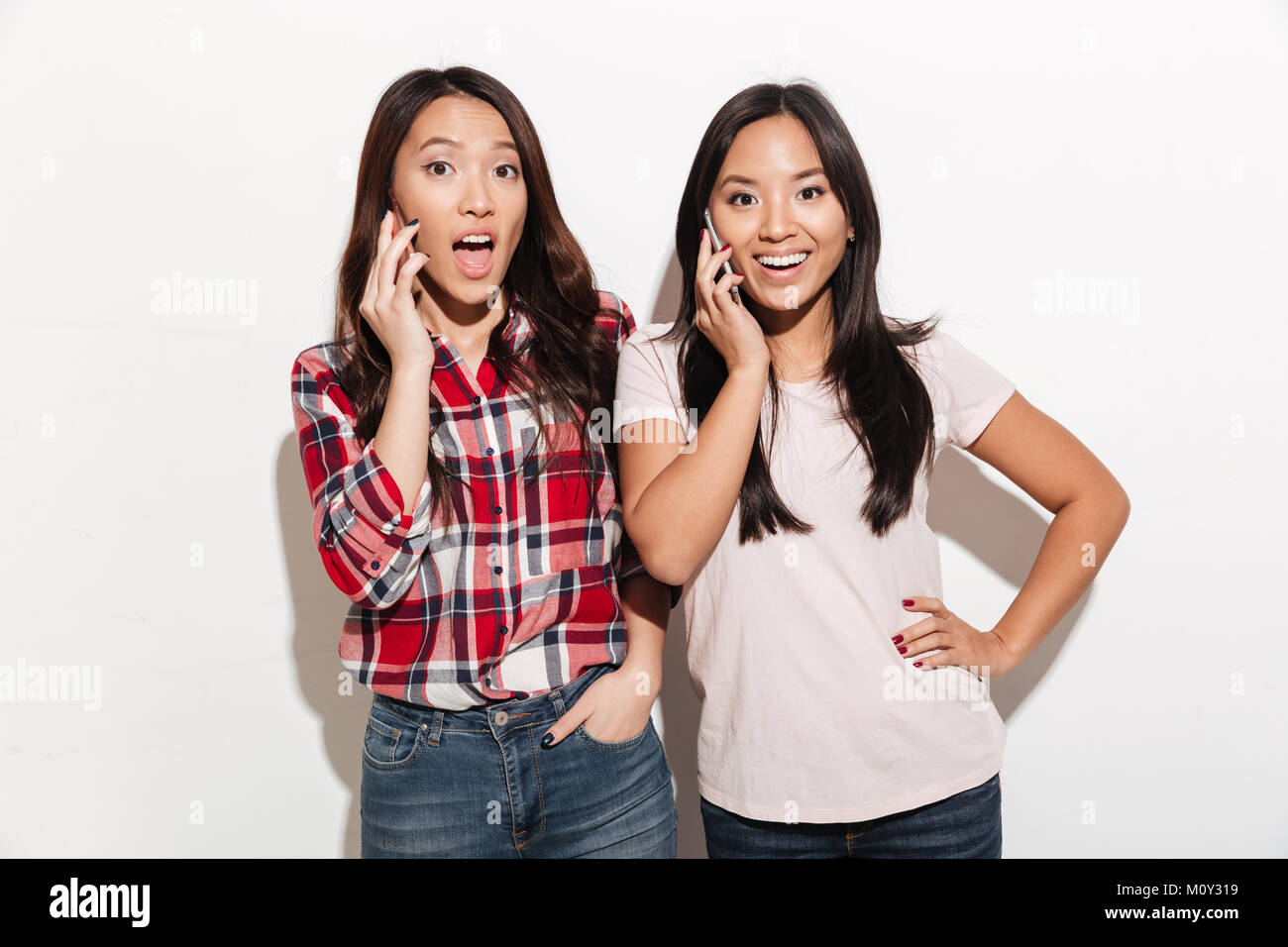 Two Asian Women Looking Phones High Resolution Stock Photography and ...