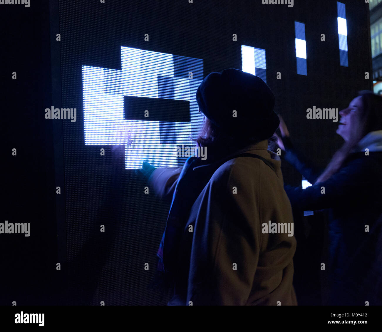 Two ladies are touching the Control no control art cube which is ...