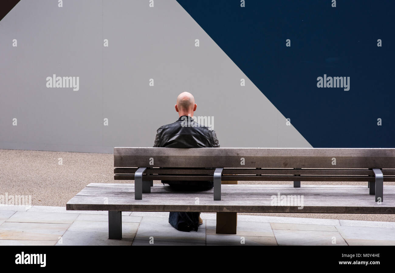 Man sitting wall hi-res stock photography and images - Alamy
